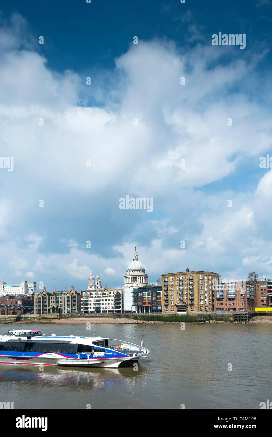 A Thames Clipper River Boat on the River Thames with the dome of St ...