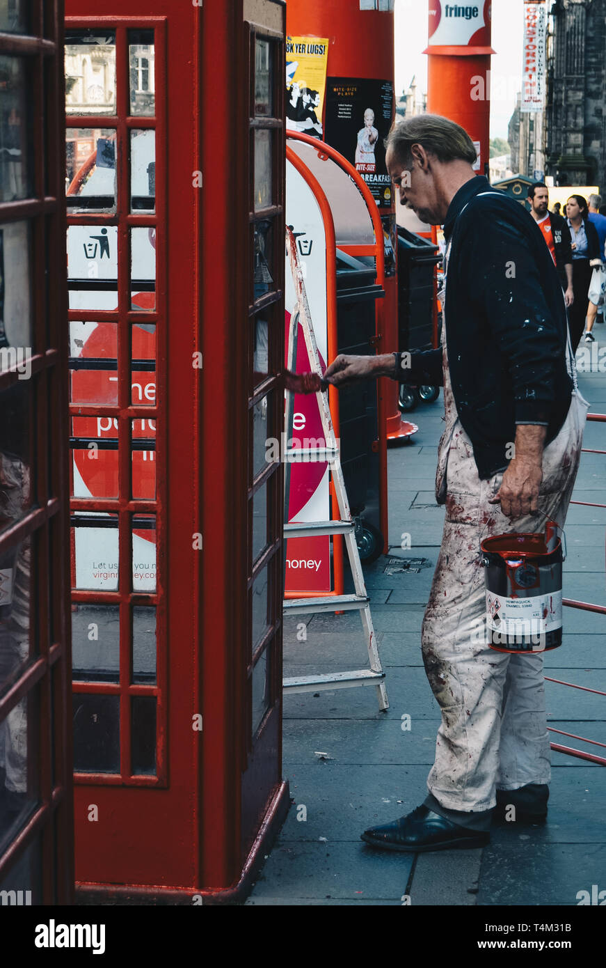 Painting a red telephone box Stock Photo - Alamy