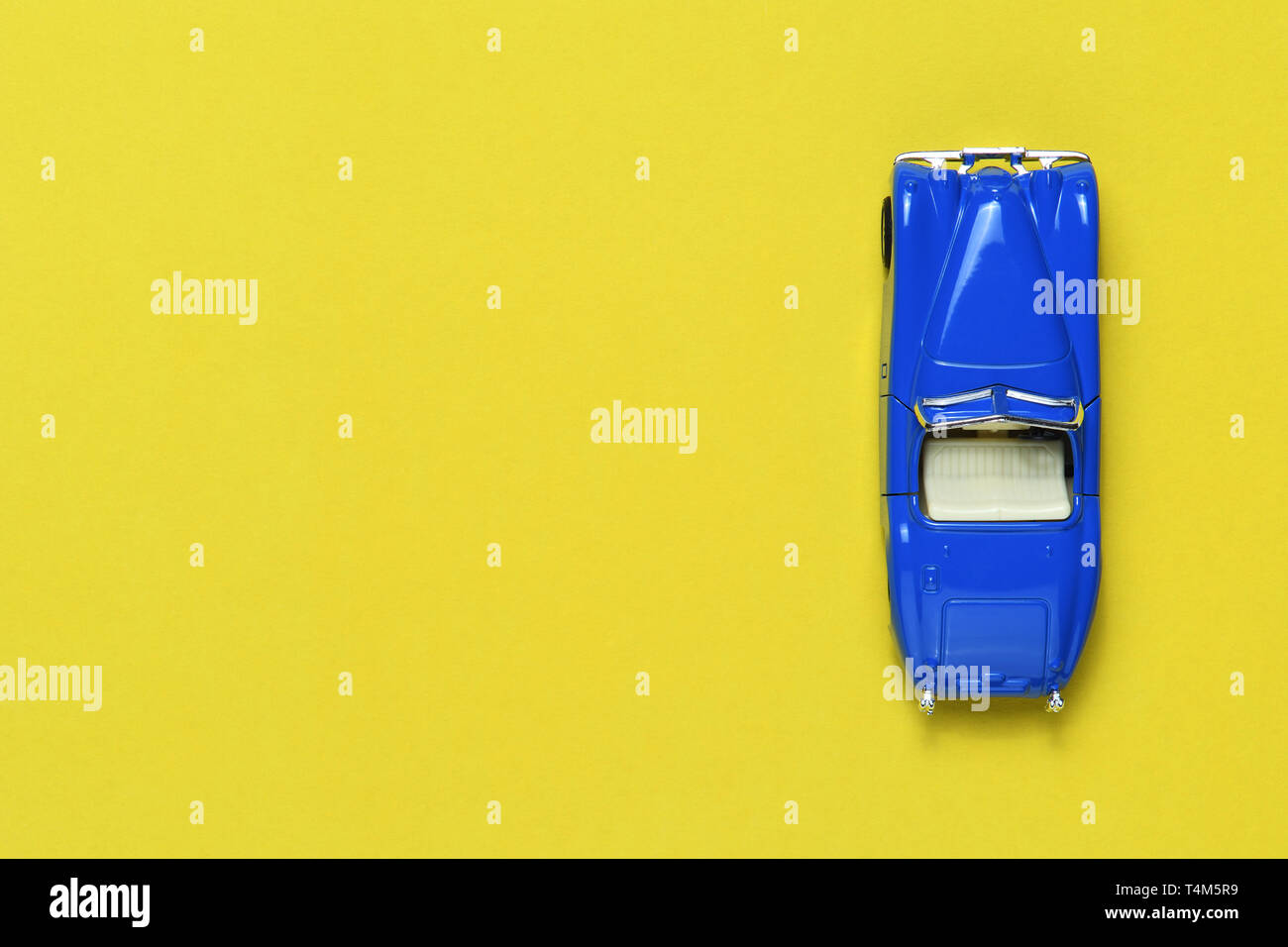 Toy car on yellow background top view Stock Photo - Alamy