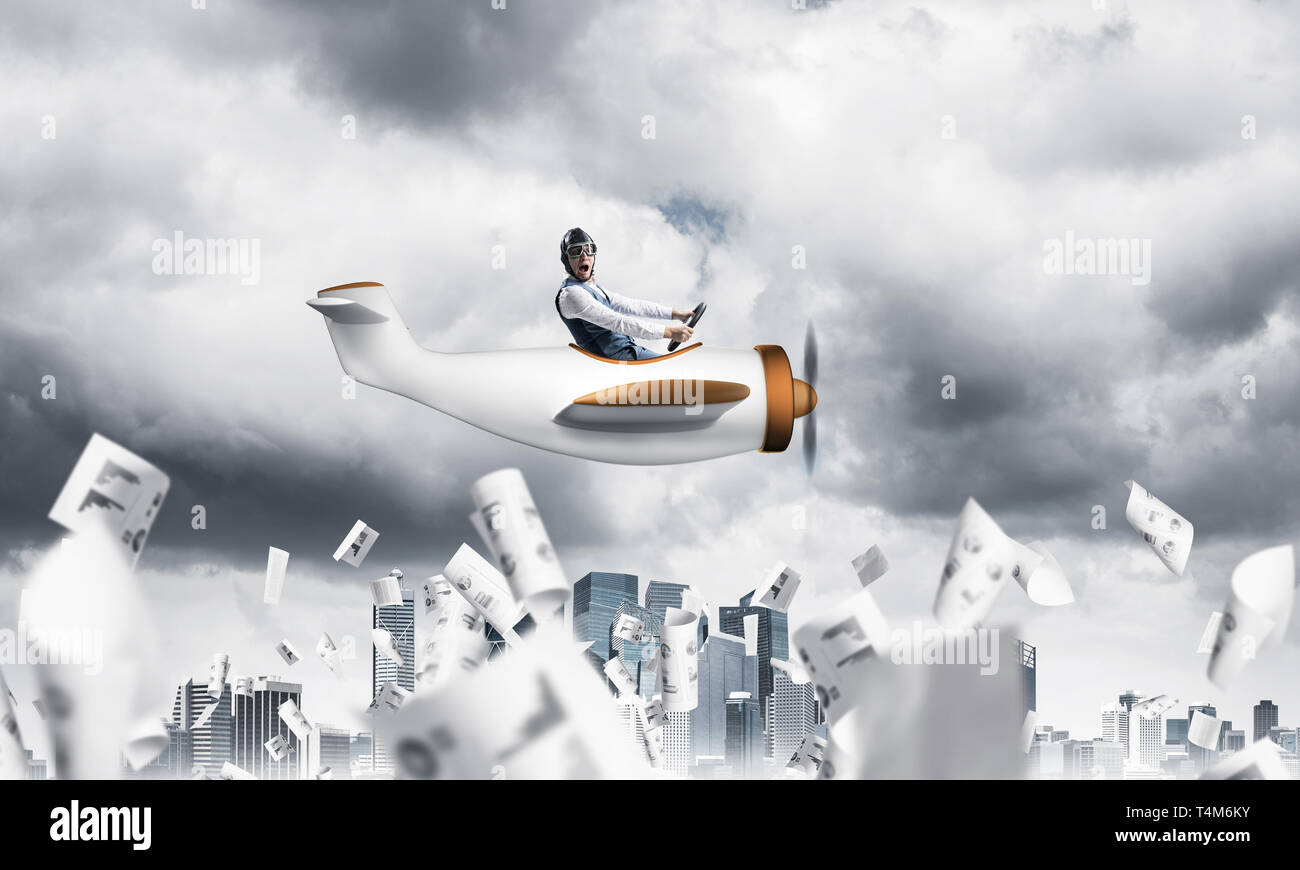 Pilot flying in small paper airplane Stock Photo - Alamy