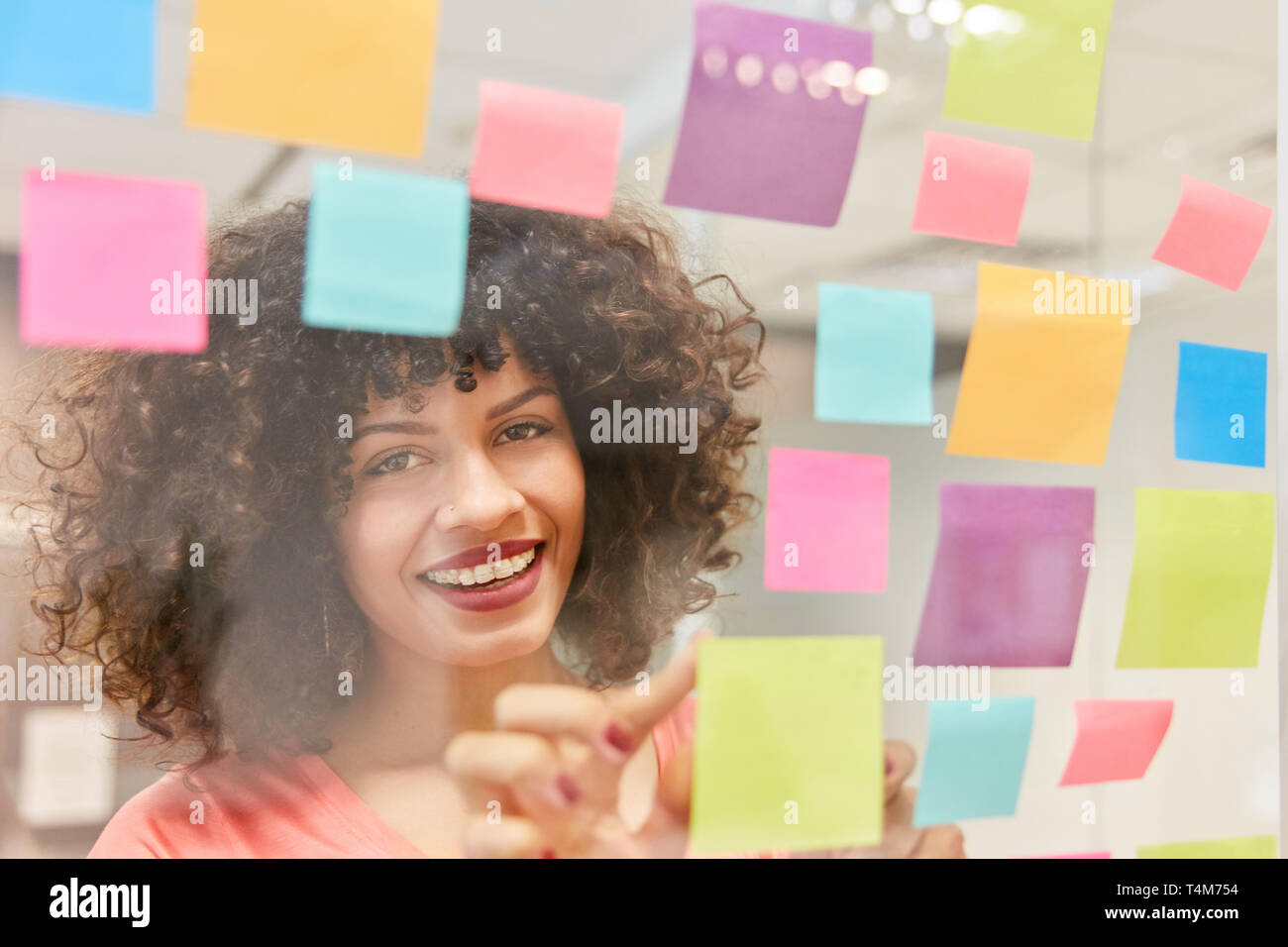 Young business woman in creative brainstorming workshop with colorful ...