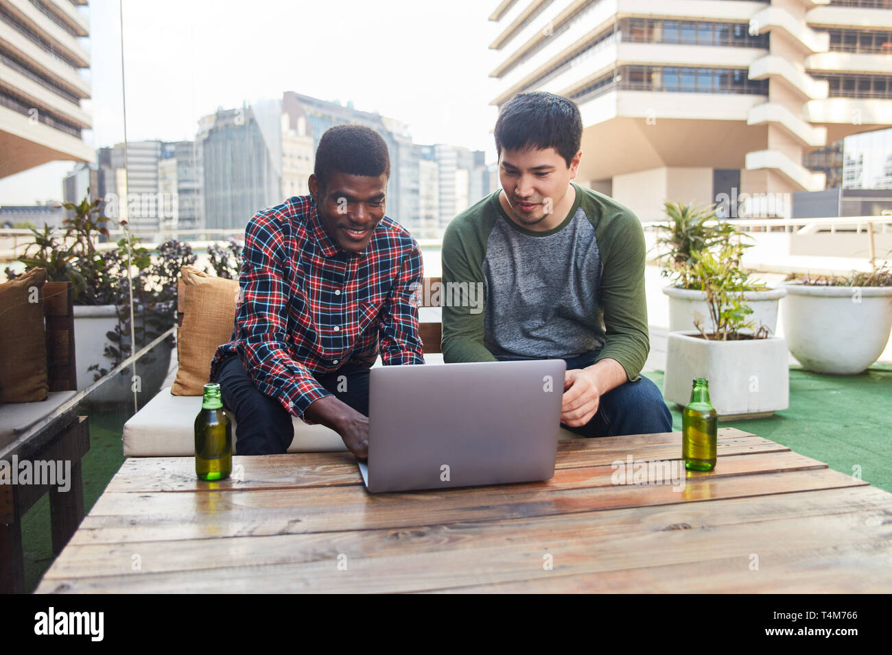 Two young men as friends look on the monitor of a laptop computer Stock ...