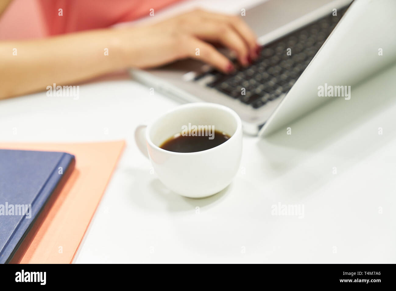 Coffee cup on the desk next to the laptop. Computer as a stimulant ...
