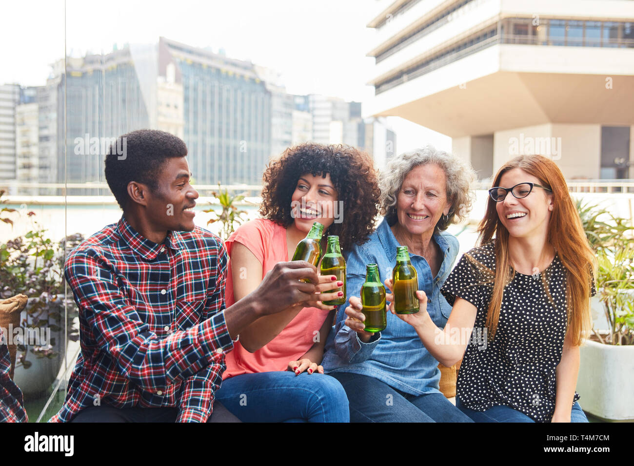 Happy colleagues team drinking beer together in front of the office ...