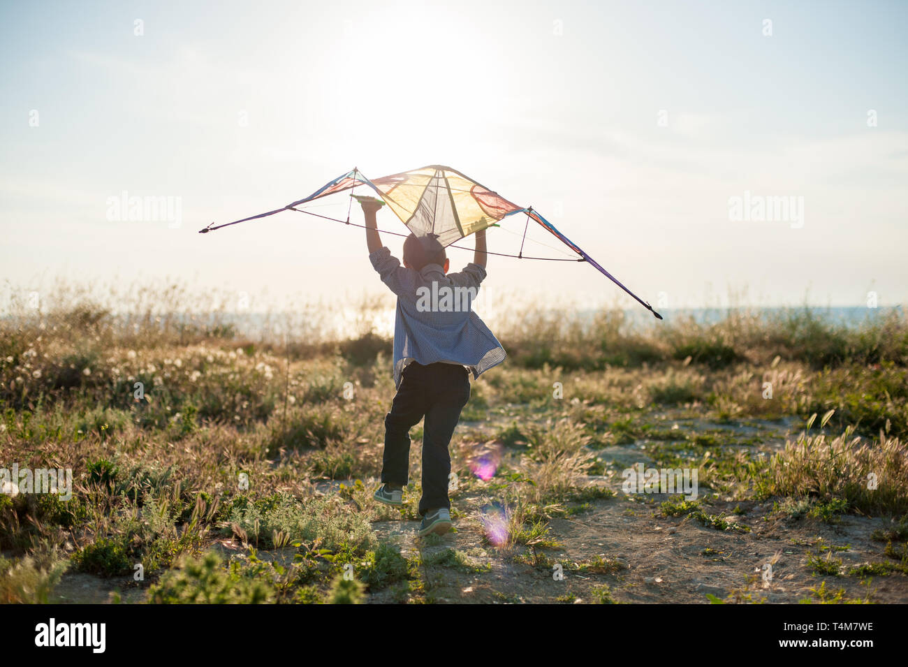 Kid running with kite hi-res stock photography and images - Alamy