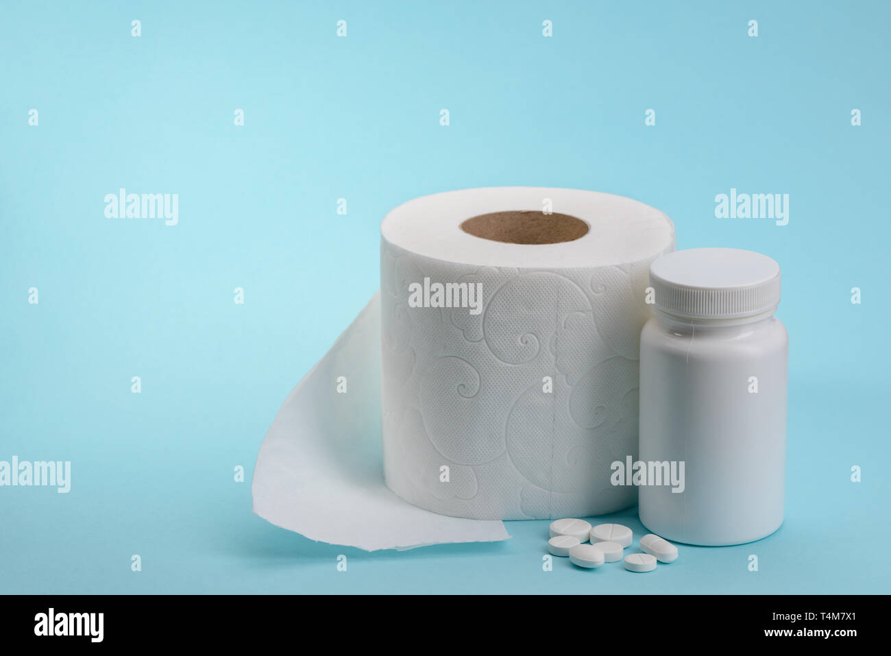Toilet paper and medicine drugs on blue background. How to treat ...