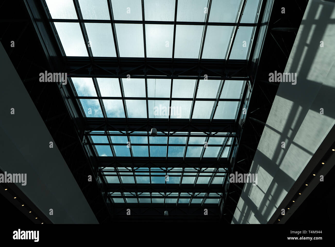 Glass ceiling in a shopping mall with a bright sun outside Stock Photo ...