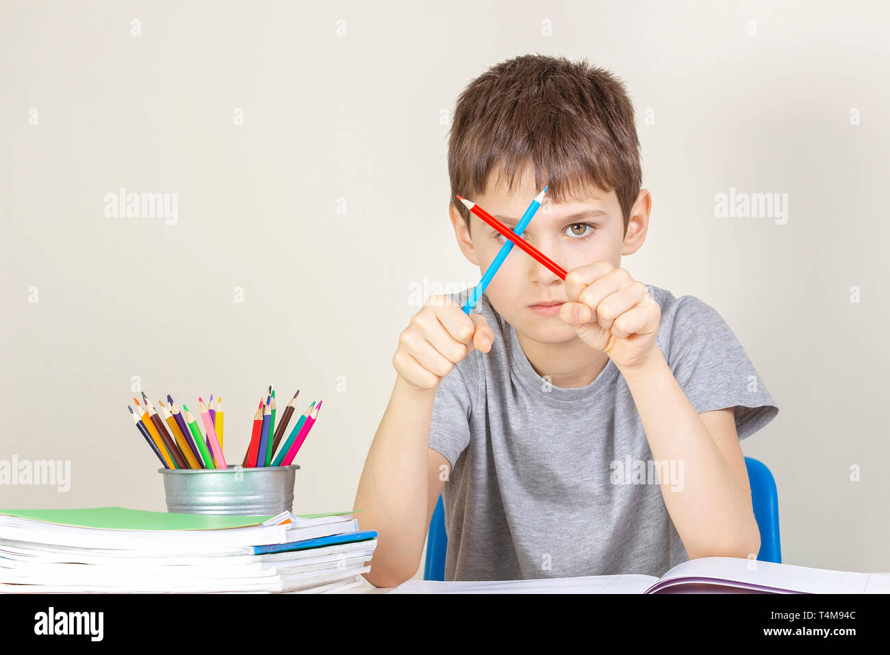 Sad angry boy have difficulties doing homework Stock Photo - Alamy