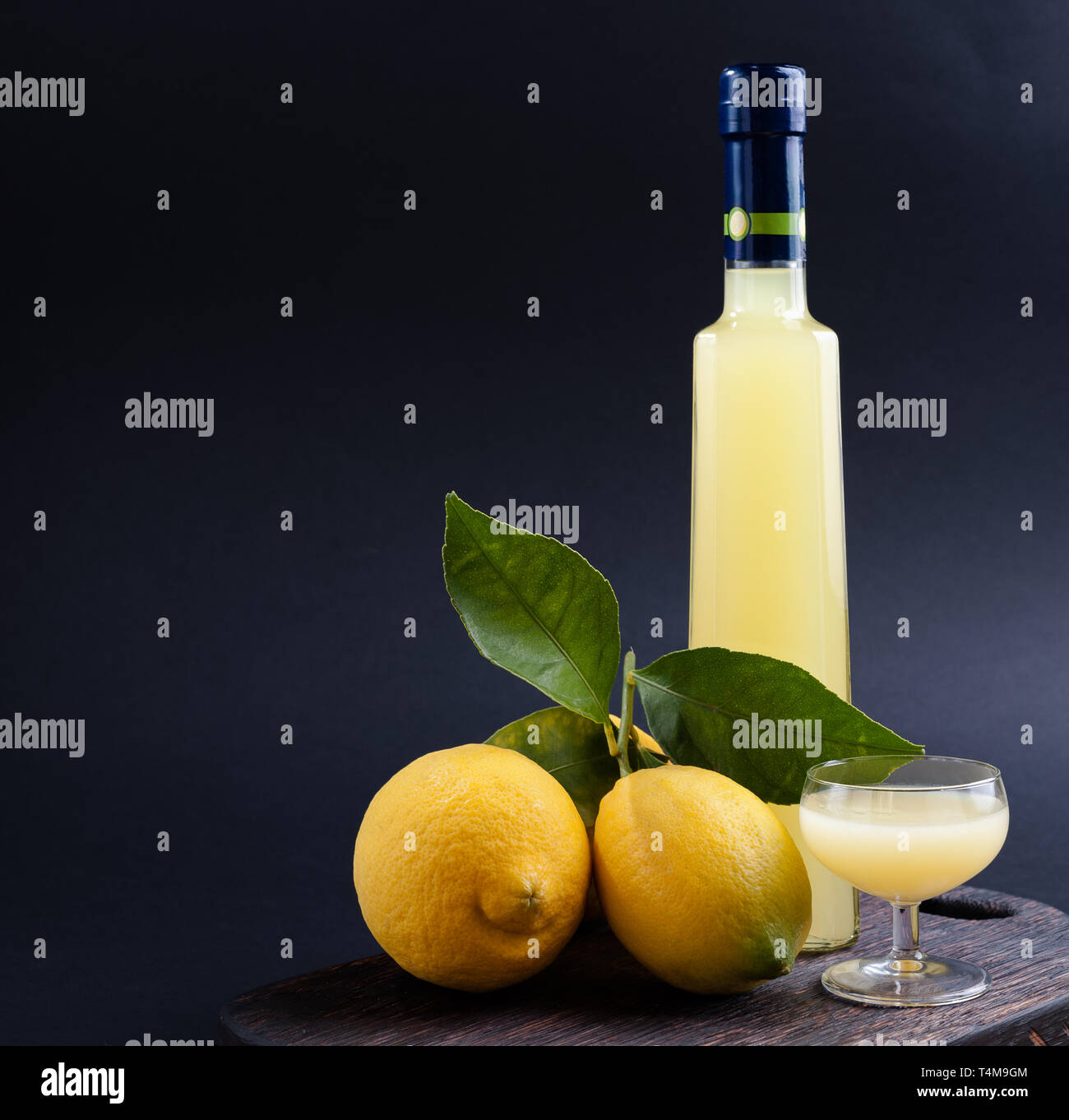 Lemoncello in a bottle on a black background, Traditional Italian ...