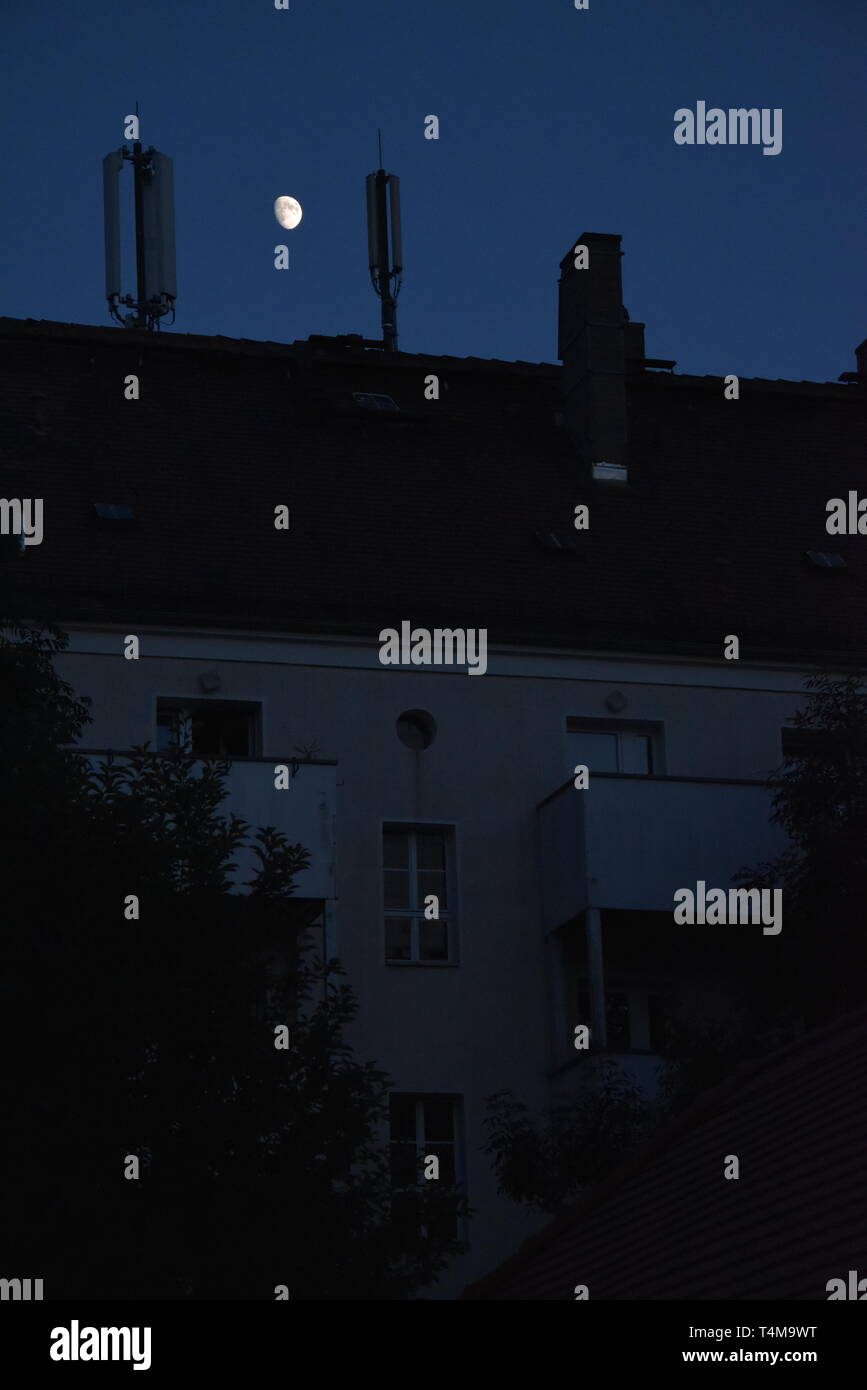 the moon shining over a building in Leipzig Stock Photo - Alamy