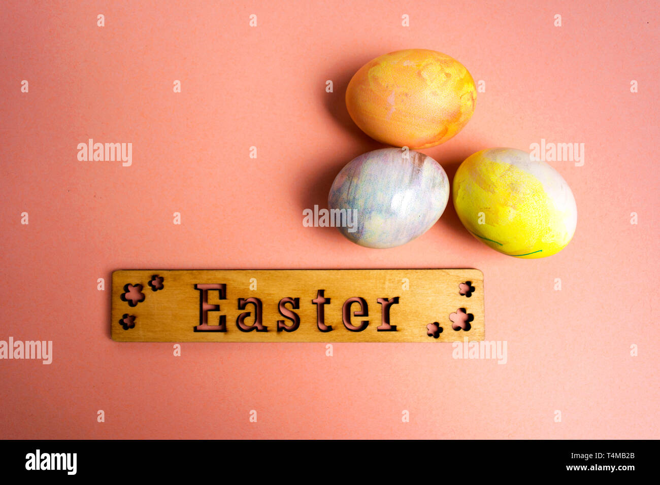 Easter note and painted Easter eggs against pink background Stock Photo ...