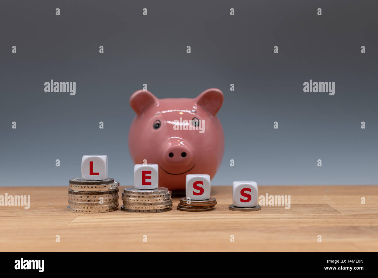 Symbol for loosing money. Dice placed on stacks of coins form the word ...