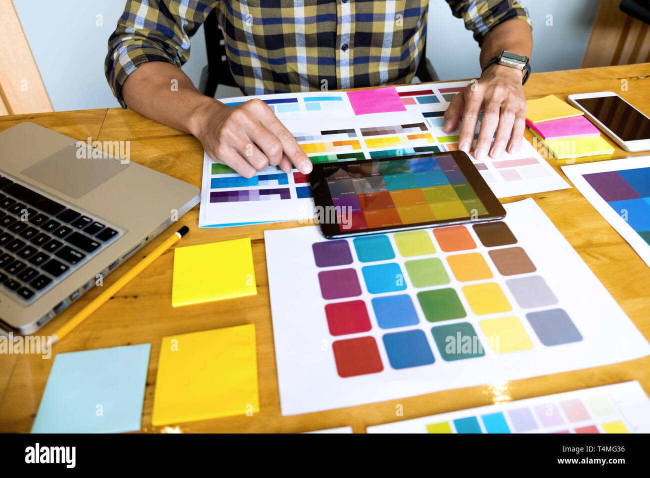 Graphic designers use the tablet to choose colors from the color bar ...