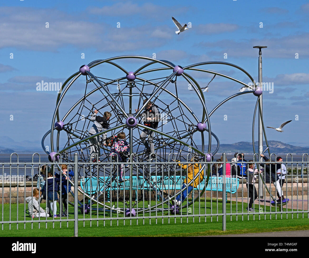 Children playing on a climbing frame. The Promenade, Morecambe ...