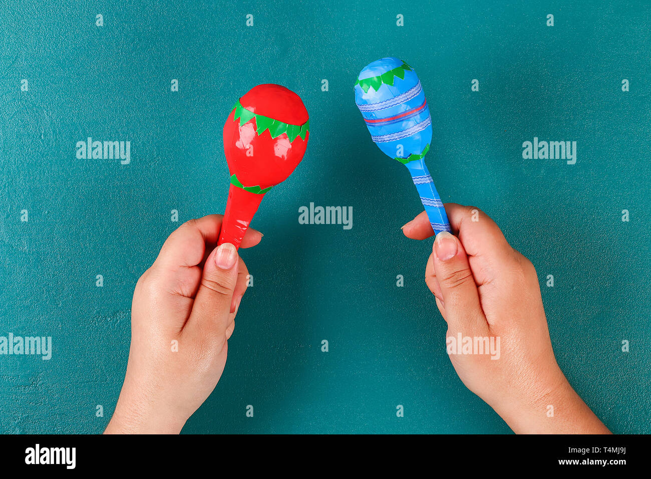 Diy cinco de mayo maracas from eggs, spoons and cereals on a green ...
