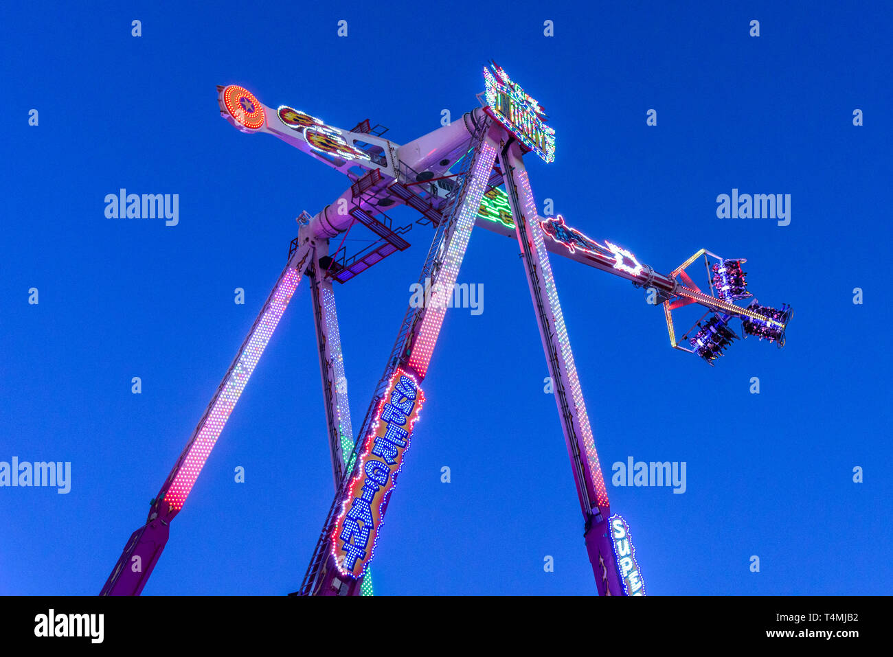 Colorful illuminated fairground attraction - huge vertical carousel ...