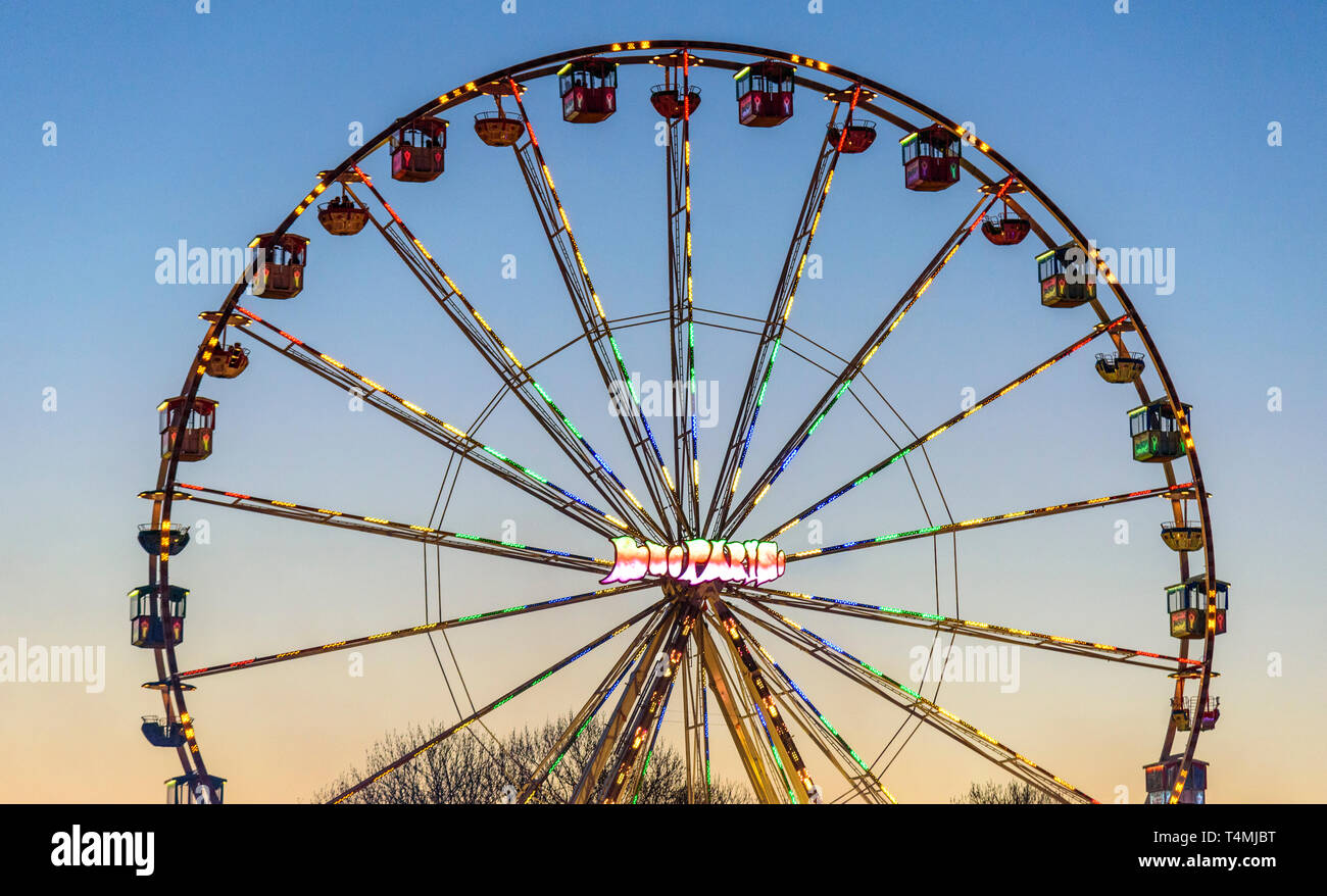 Colorful illuminated fairground attractions - ferris wheel Stock Photo ...