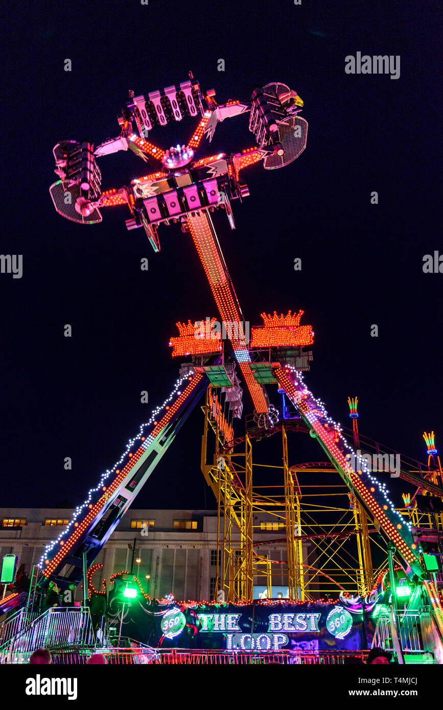 Colorful illuminated fairground attraction - huge vertical carousel ...