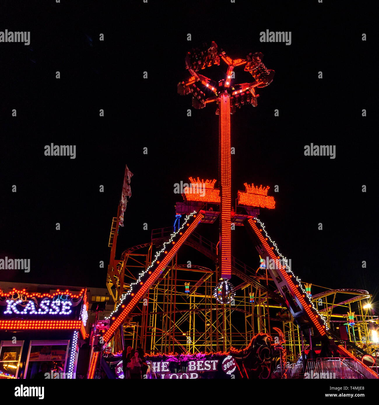 Colorful illuminated fairground attraction - huge vertical carousel ...