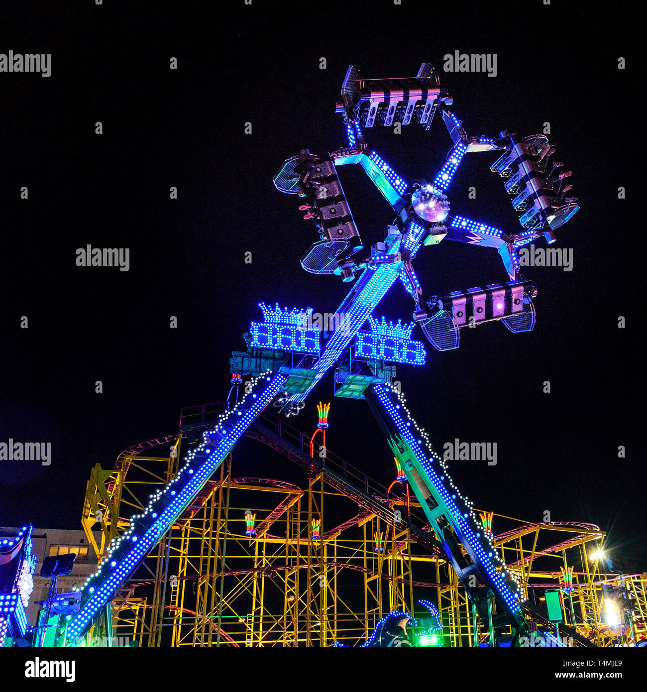 Colorful illuminated fairground attraction - huge vertical carousel ...