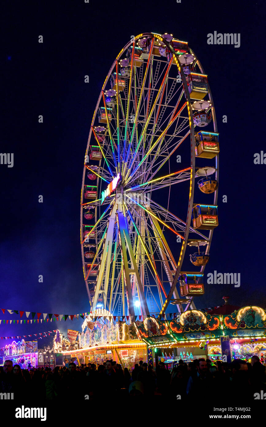 Colorful illuminated fairground attractions - ferris wheel Stock Photo ...