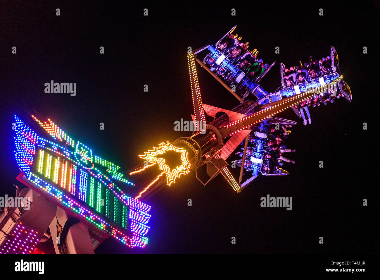 Colorful illuminated fairground attraction - huge vertical carousel ...