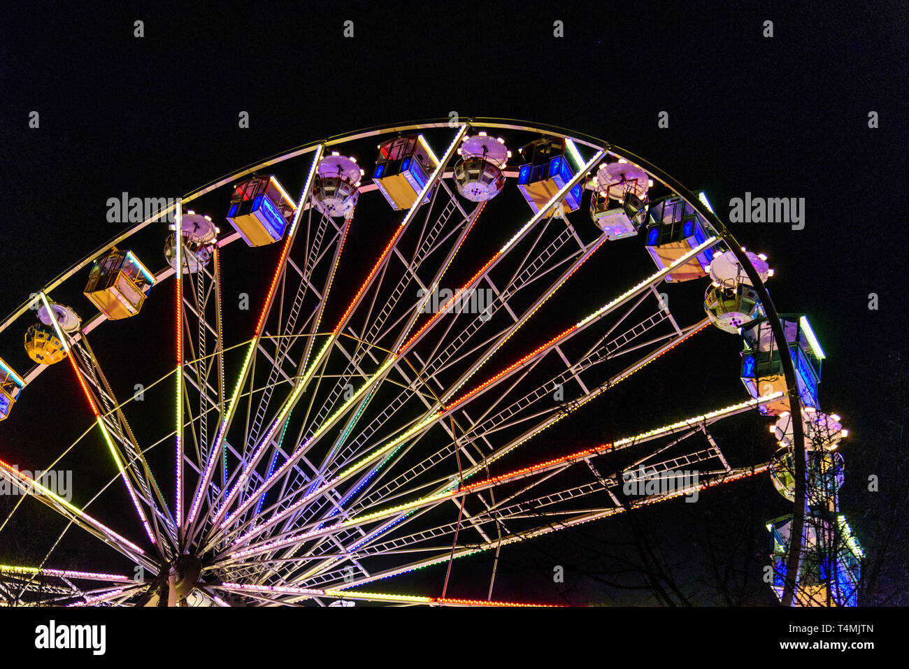 Colorful illuminated fairground attractions - ferris wheel Stock Photo ...