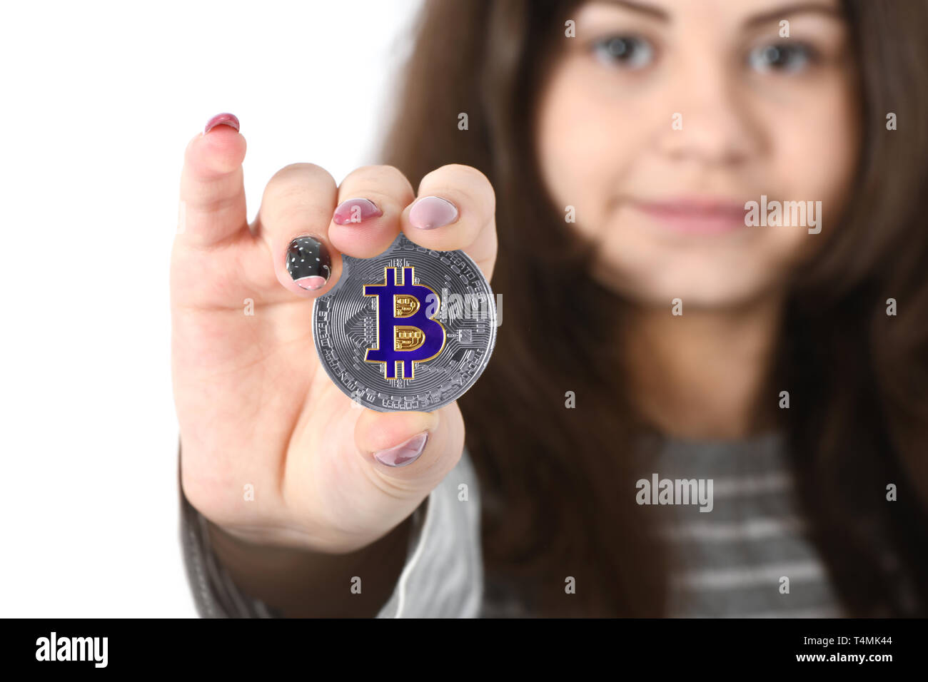 Pretty Girl holding in front of her new silver cryptocurrency bitcoin ...