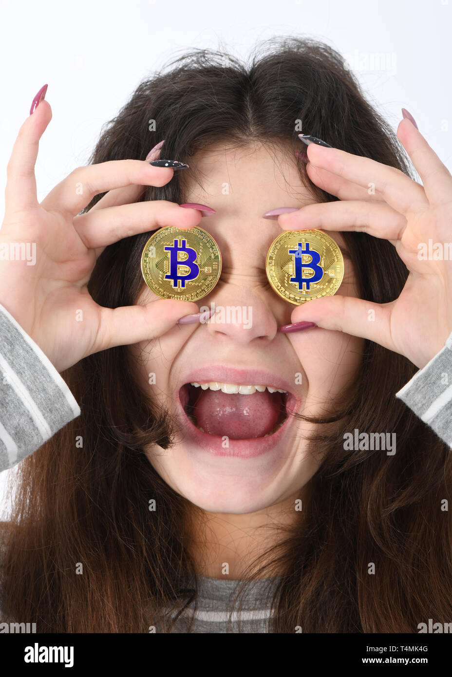 Pretty Girl keeps the eye instead two golden cryptocurrency bitcoin in ...