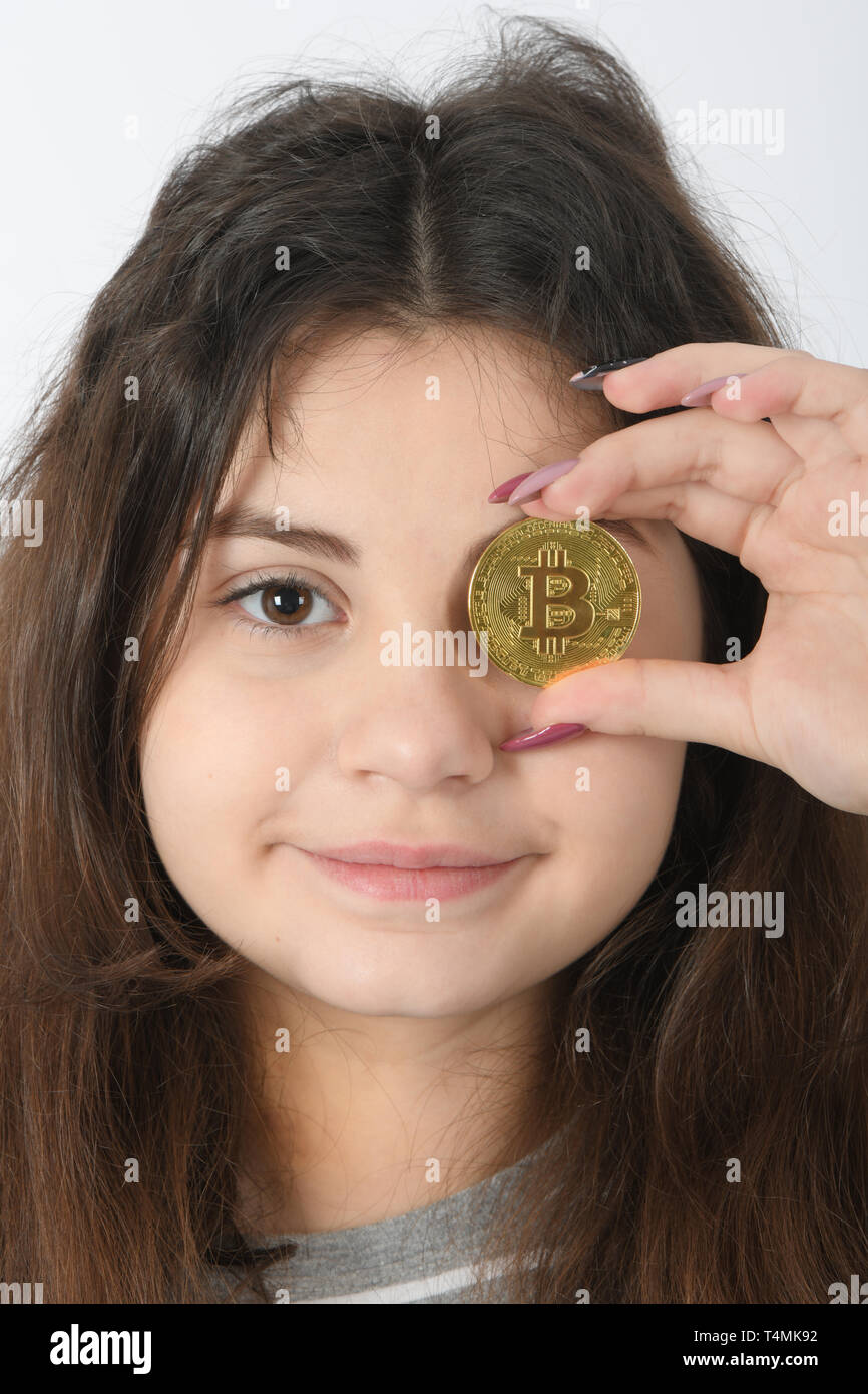 Pretty Girl holding in front of her new golden cryptocurrency bitcoin ...