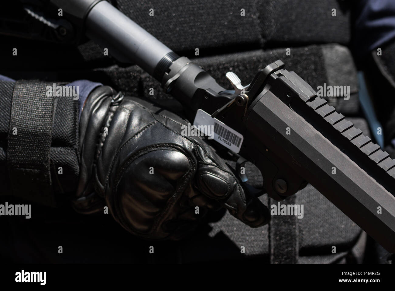 Black hands holding gun hi-res stock photography and images - Alamy