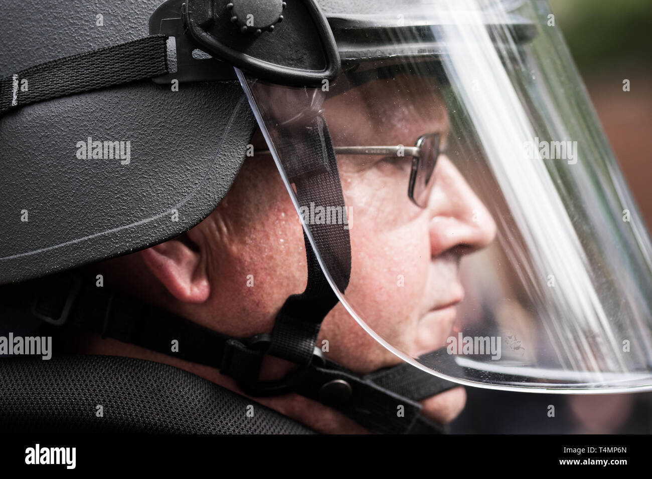 Close Up of Police Officer in Riot Gear Wearing Helmet and Face shield ...