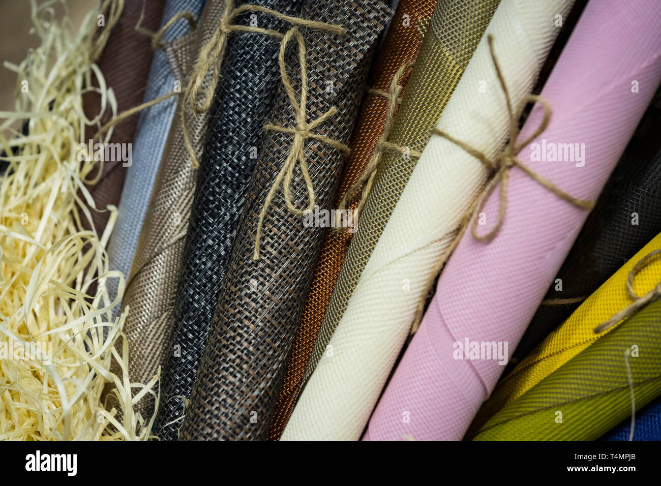 Rolls of wrapping paper binding with rope Stock Photo - Alamy