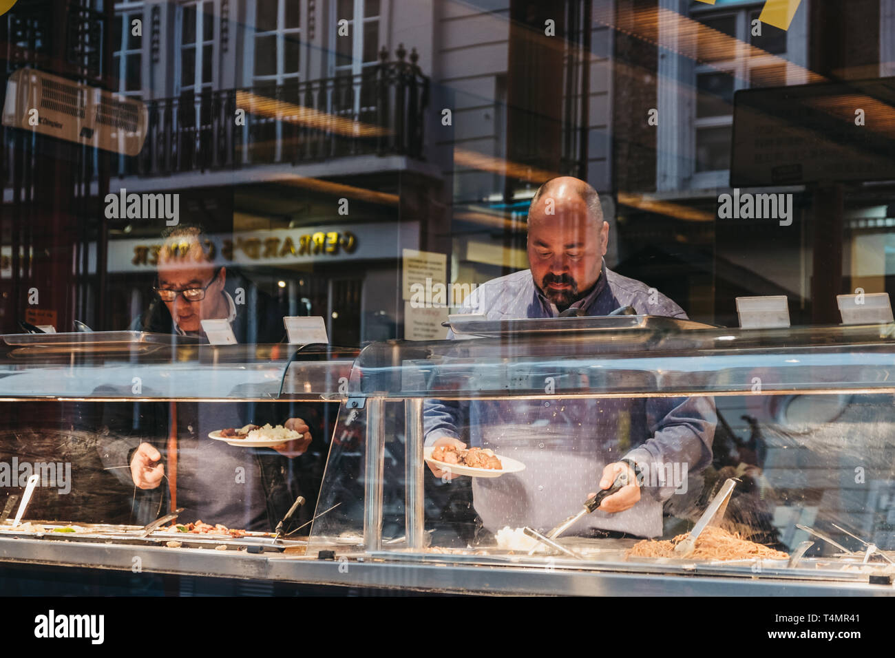 London, UK - April 13, 2019: Customers seen through the window of ...