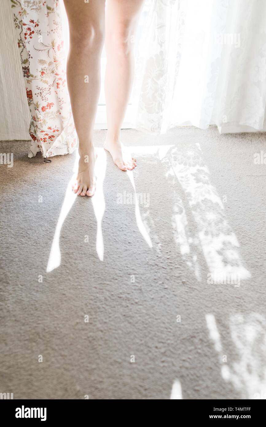 Woman's barefoot in window light - shadow of legs - sunny light Stock ...