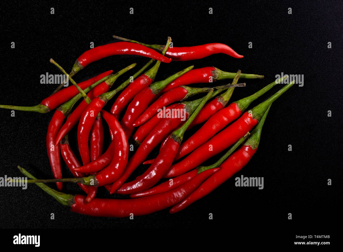 Pods of red hot pepper isolated on black color background. Copy space ...