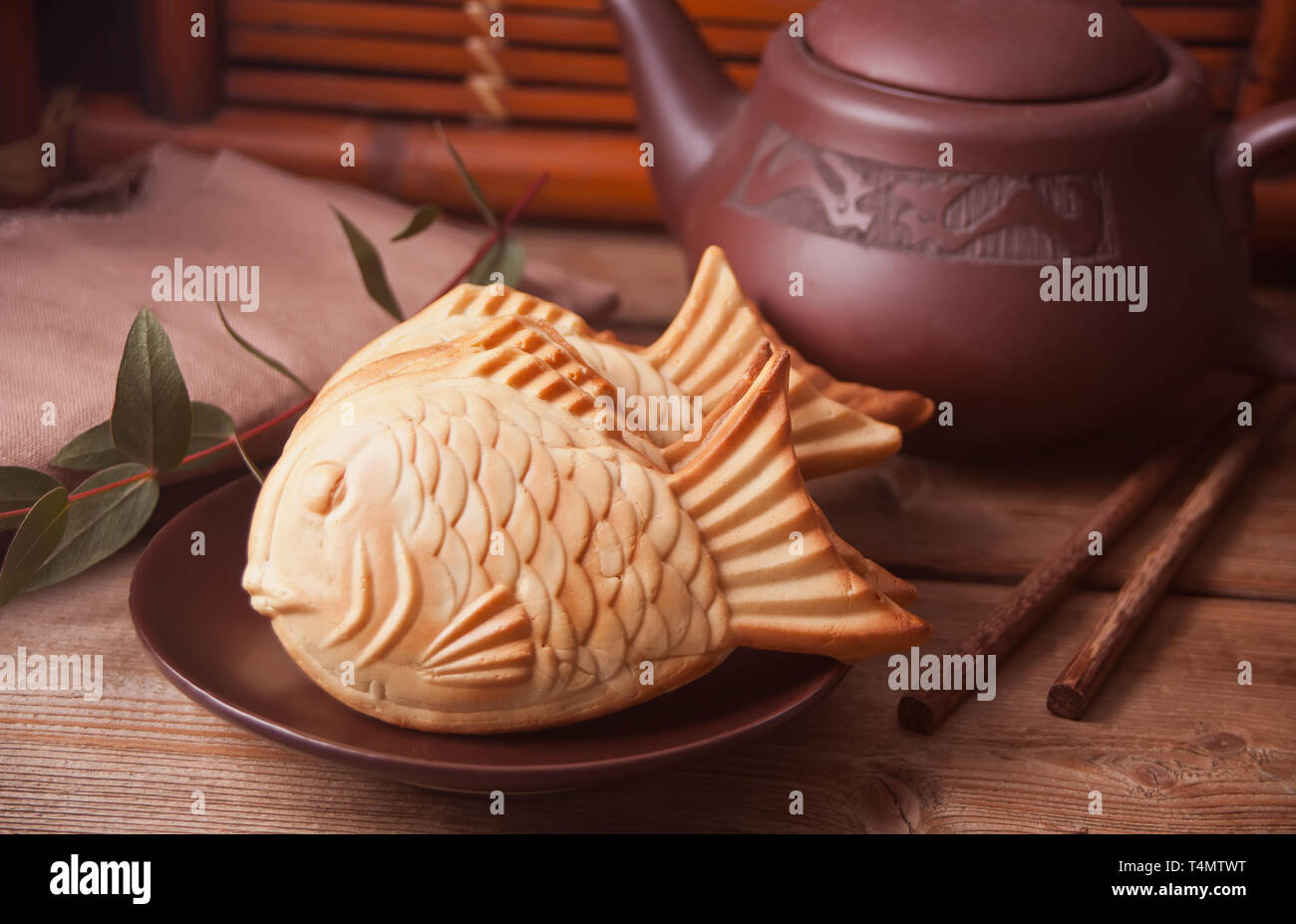 Taiyaki Japanese street food fish-shaped sweet waffle on wooden table ...