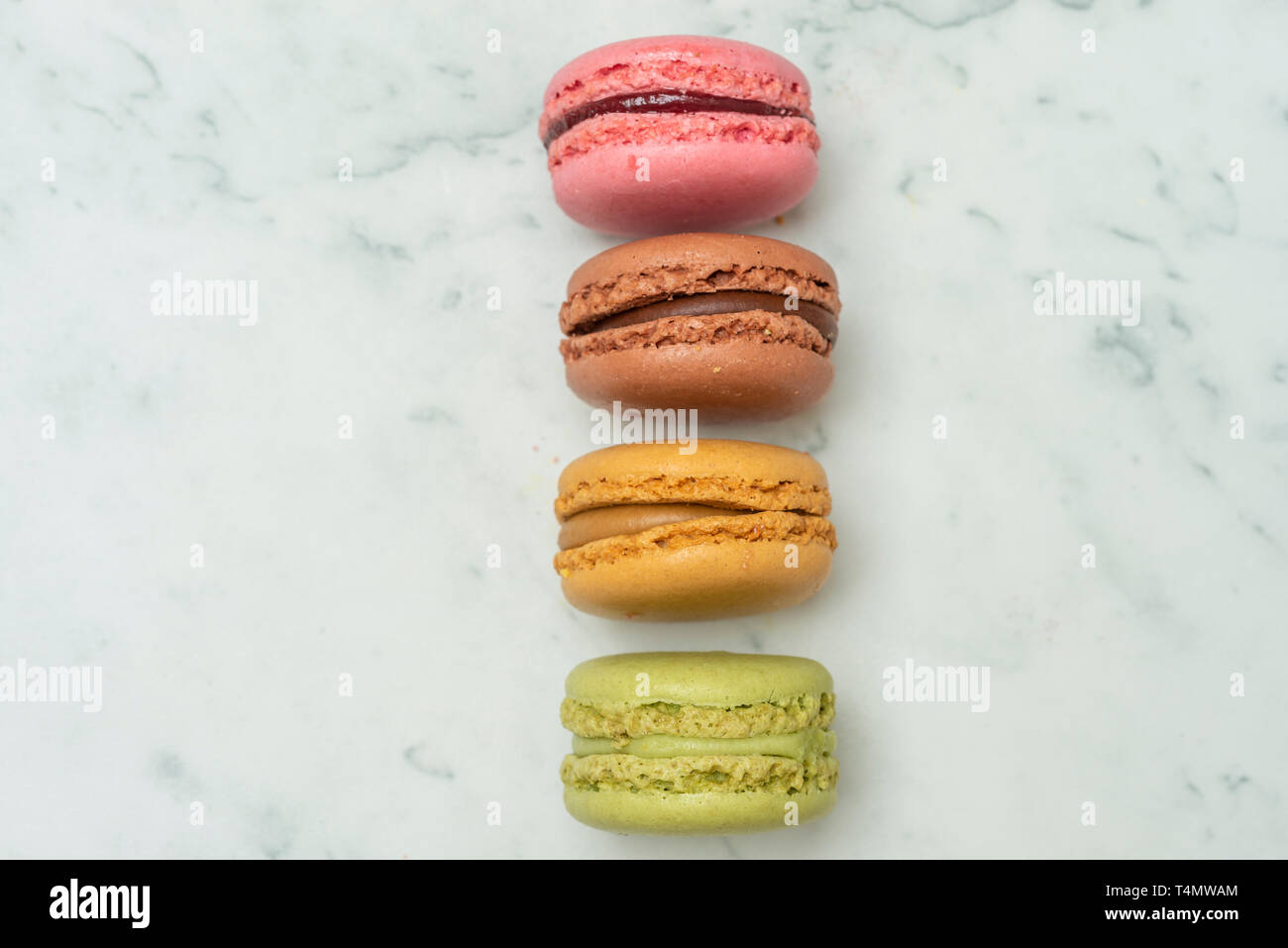 Above view of colorful macaroons on a marble background Stock Photo - Alamy