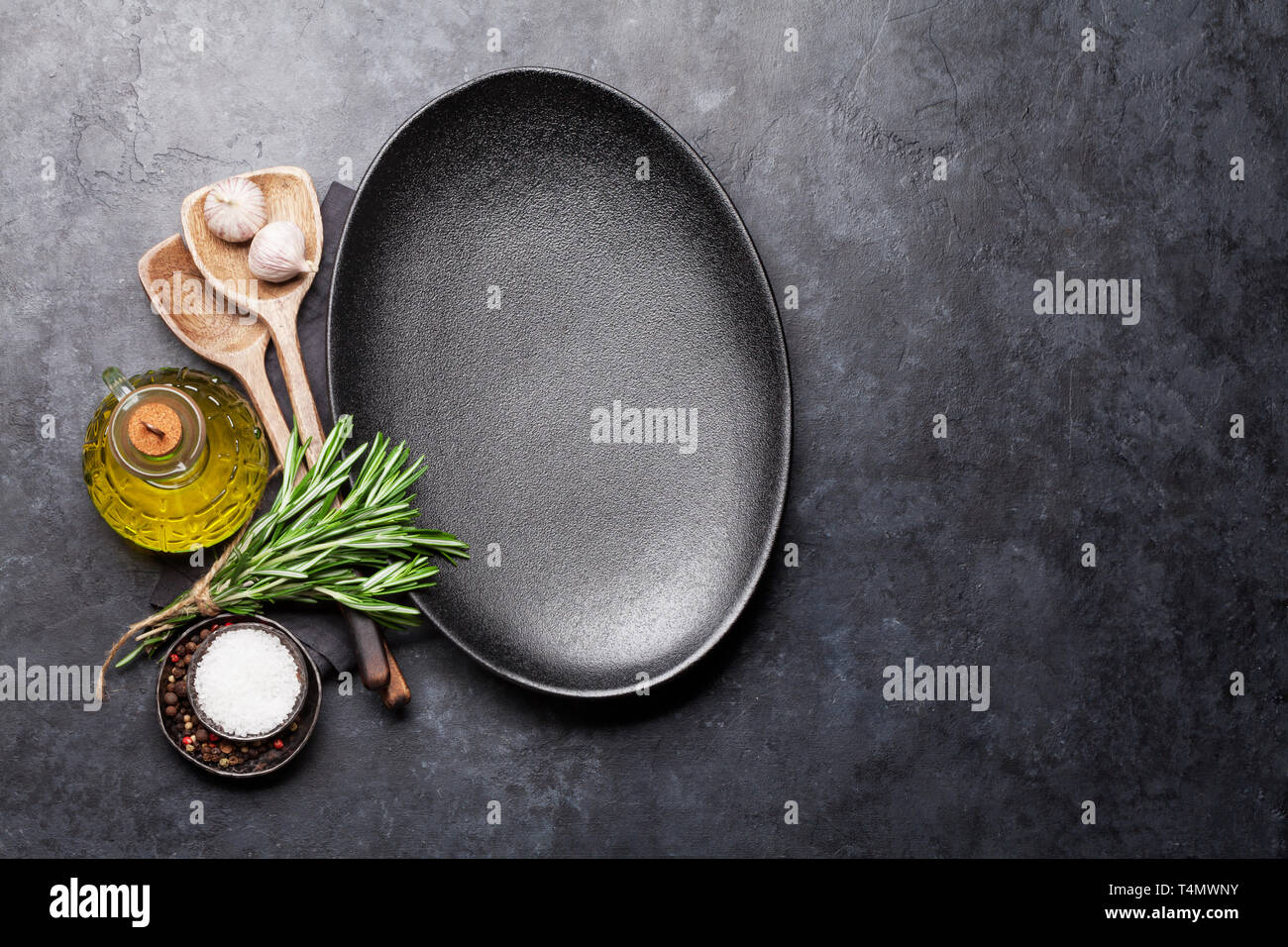 Cooking ingredients and utensils on stone table. Top view with empty ...