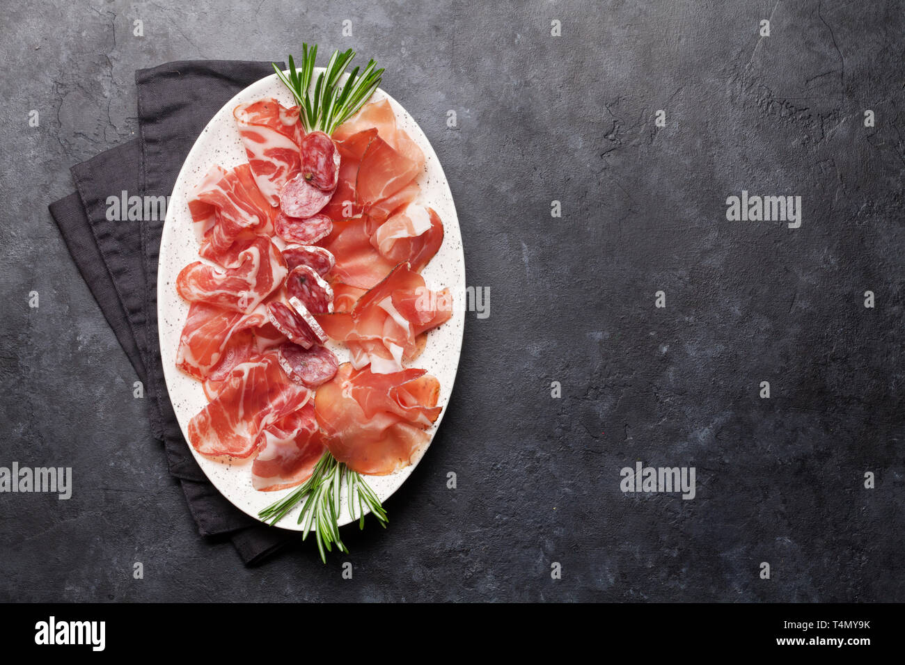 Traditional spanish jamon, prosciutto crudo, italian salami, parma ham ...