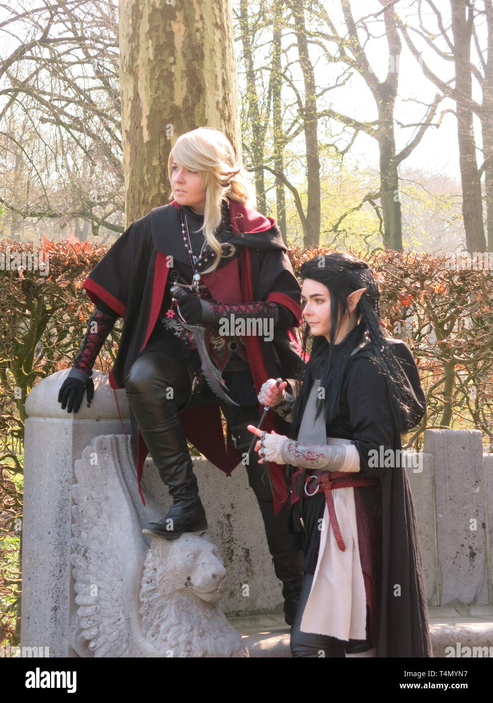 Two young women in fancy-dress costume pose in the grounds of De Haar ...