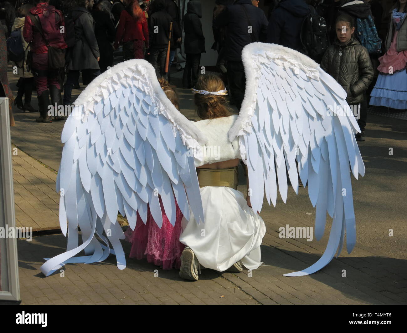 Rear view of girl with large angel wings; her costume at 'Viva Elfia ...