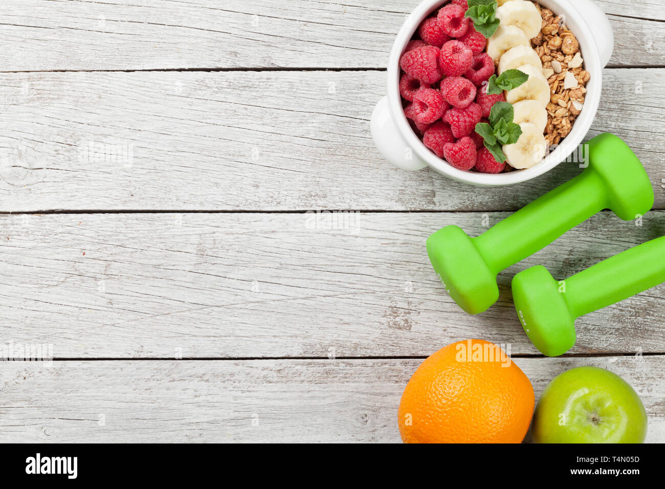 Healthy food and fitness concept. Salad, fruits, vegetables, nuts and ...