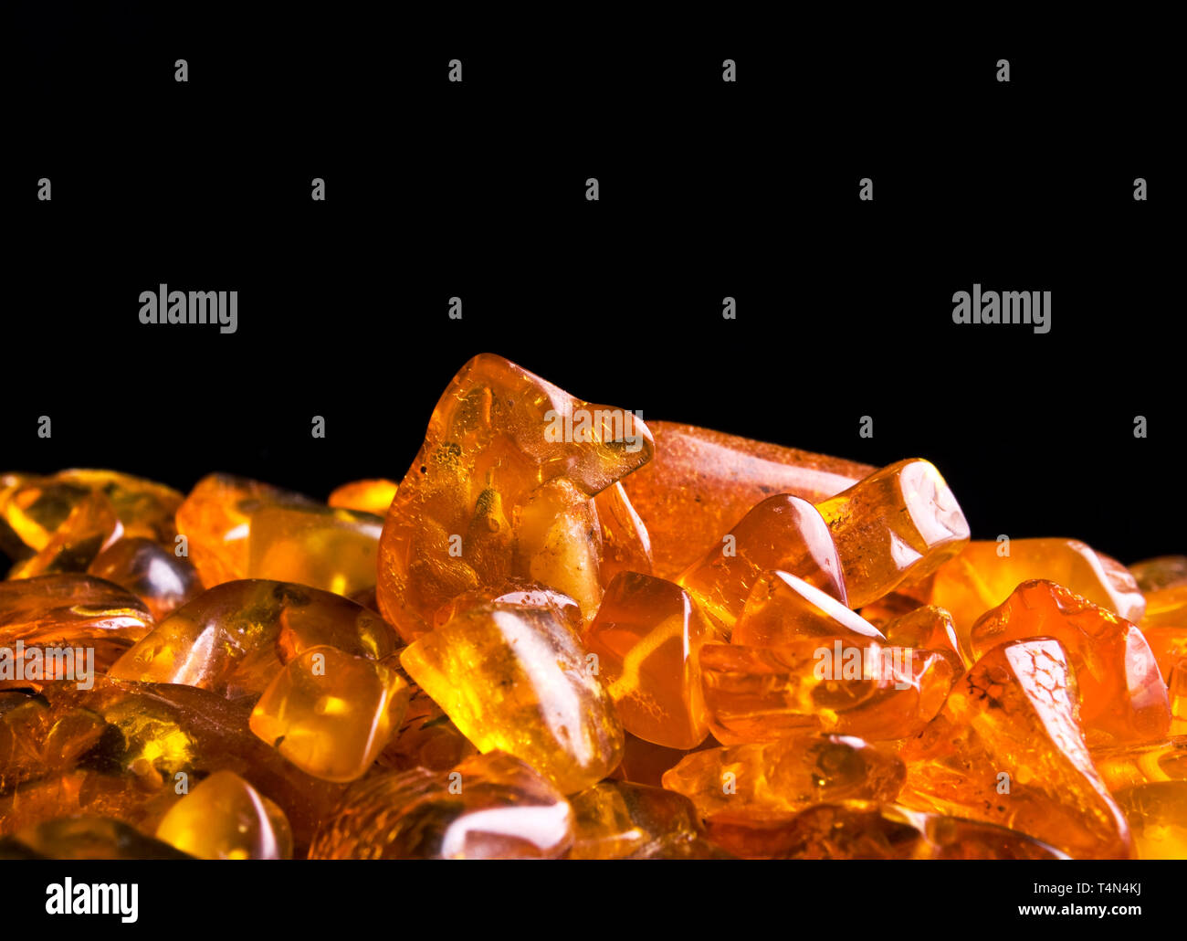 Amber on black background with copy space Stock Photo - Alamy