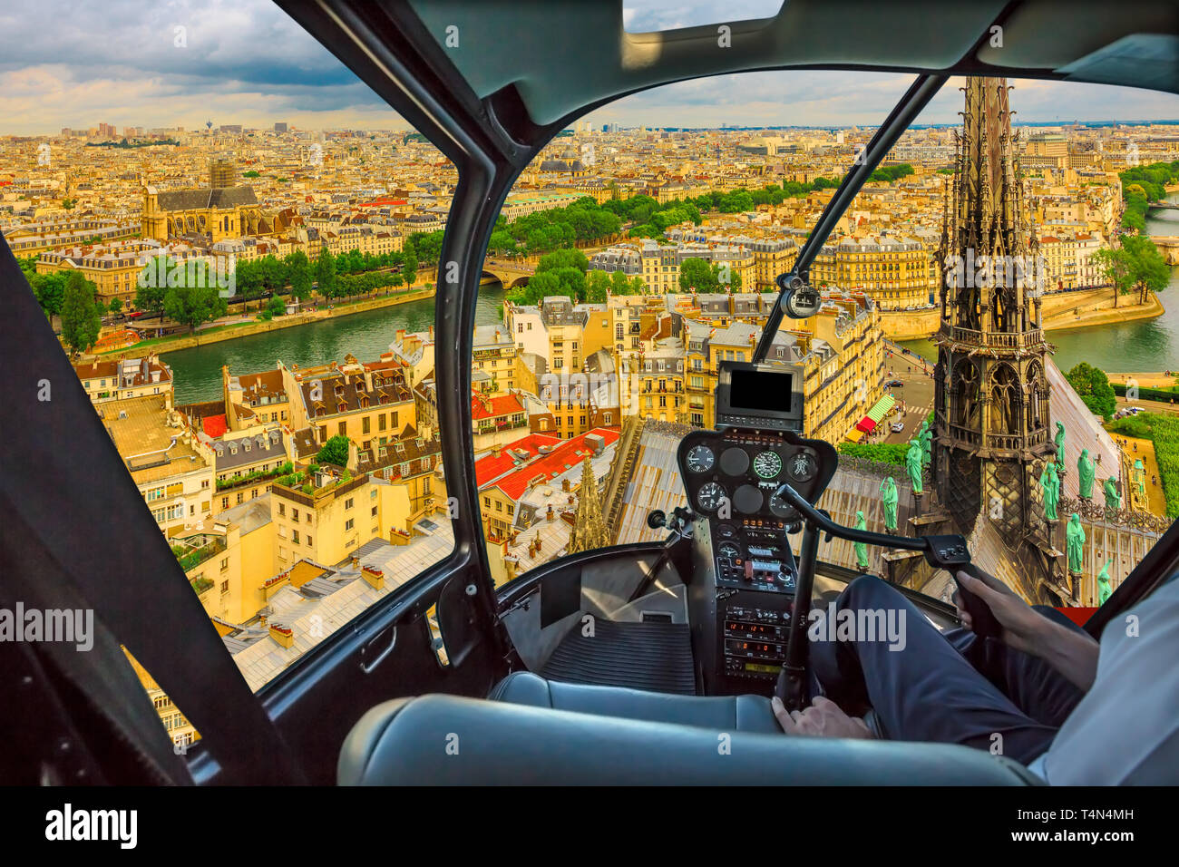 Helicopter cockpit flying on Notre Dame church with its spire and on ...