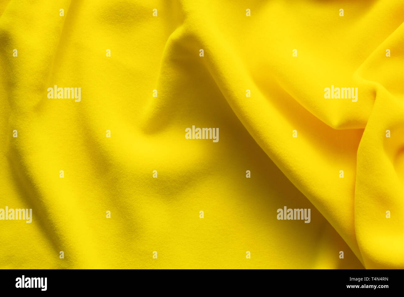 Texture of vibrant yellow fleece, soft napped insulating fabric made of ...