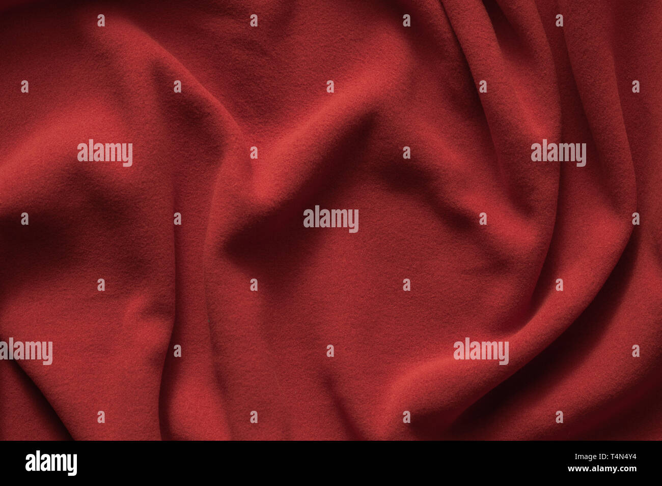 Texture of deep red fleece, soft napped insulating fabric made of ...