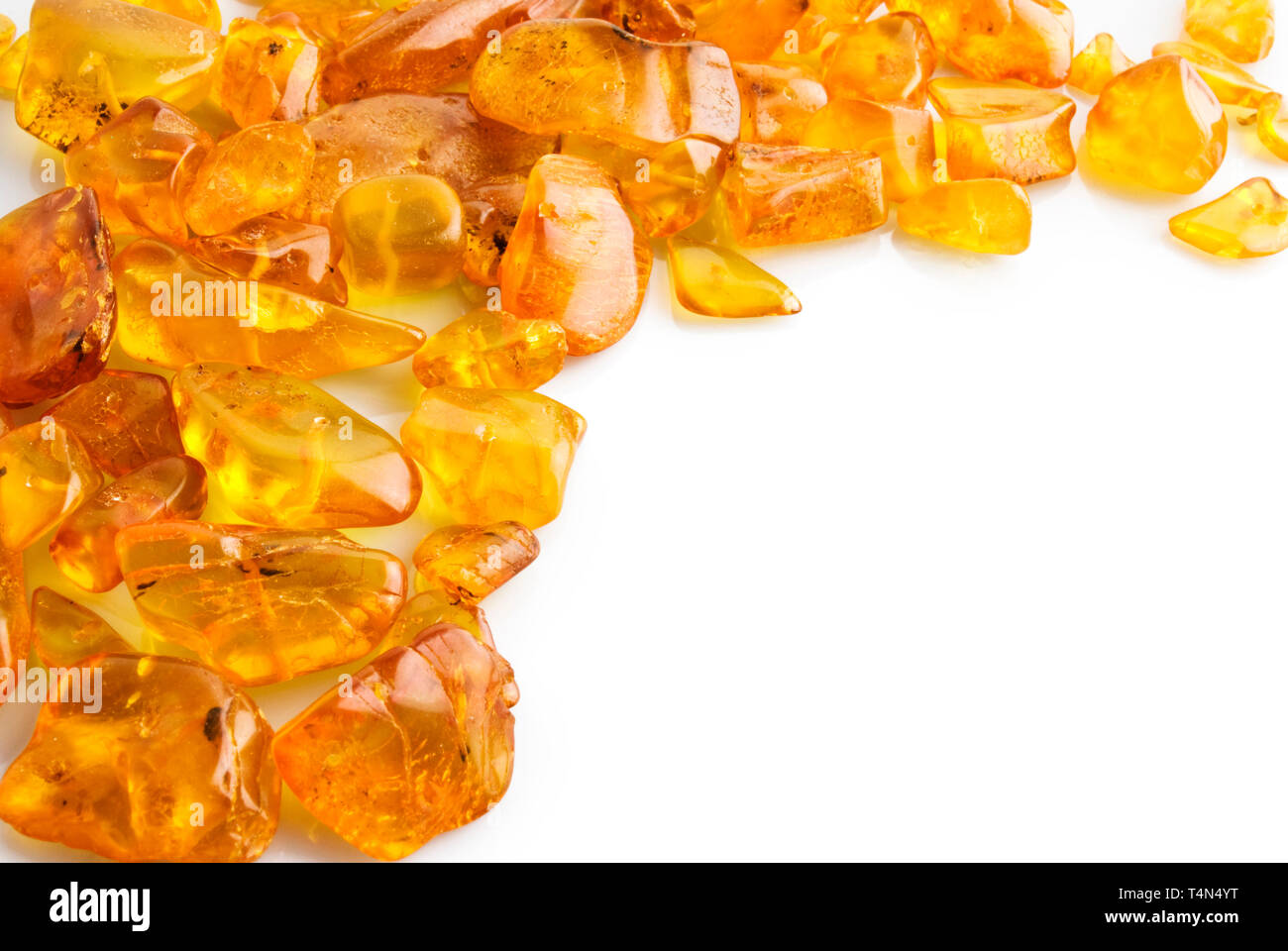 Amber on white background with copy space Stock Photo - Alamy