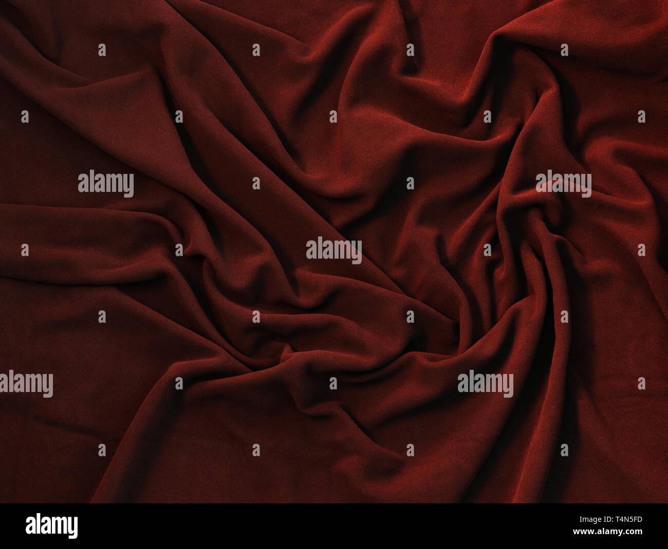 Wavy texture of deep red fleece, soft napped insulating fabric made of ...