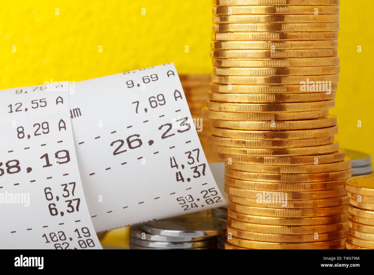 Cash register paper receipt check with coins stack closeup Stock Photo ...